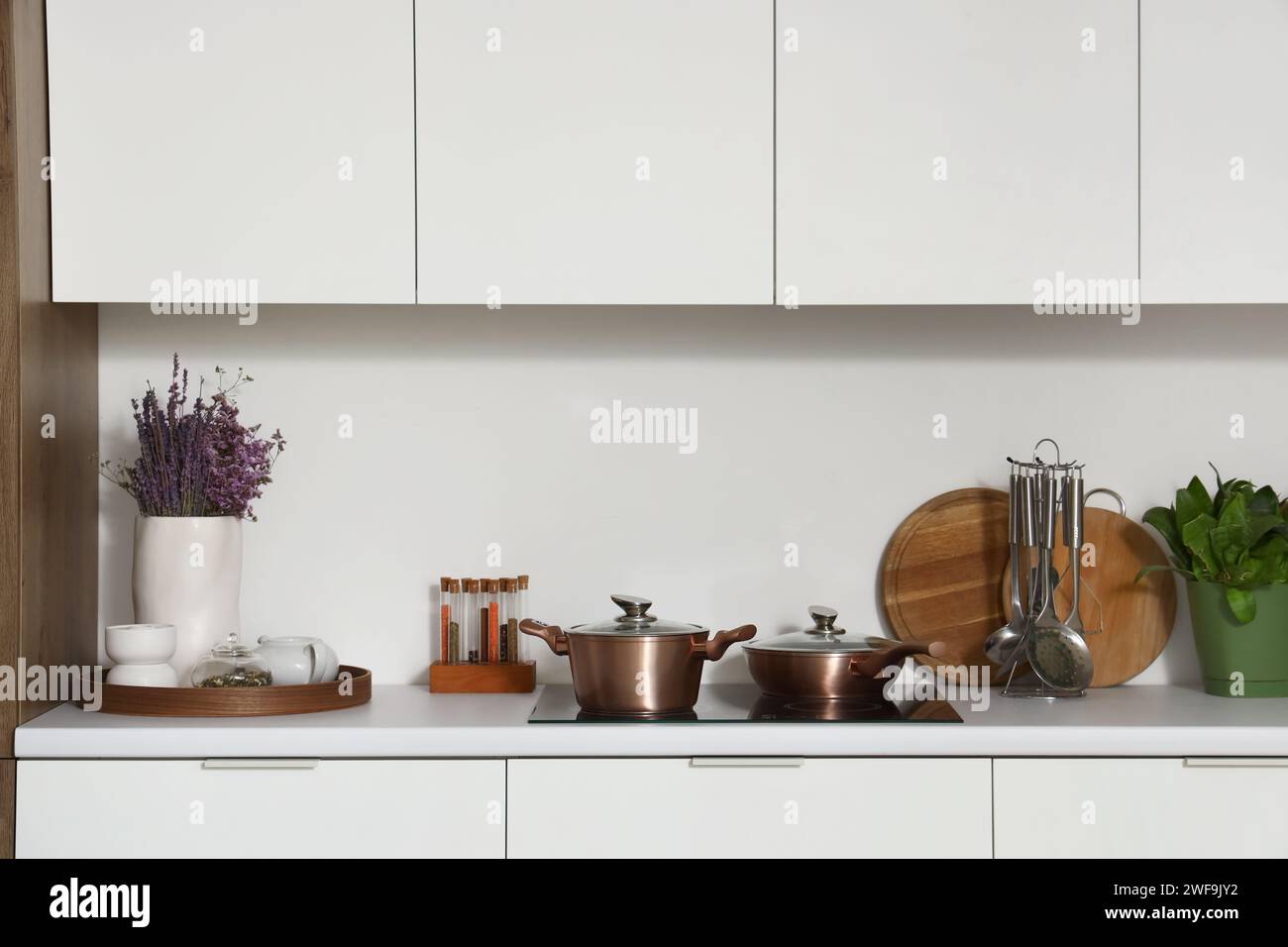 Interior of modern kitchen with utensils and electric stove on white ...