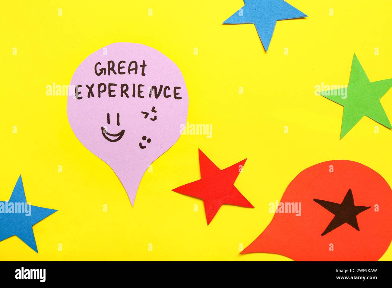 Speech bubbles with rating stars on yellow background, closeup ...
