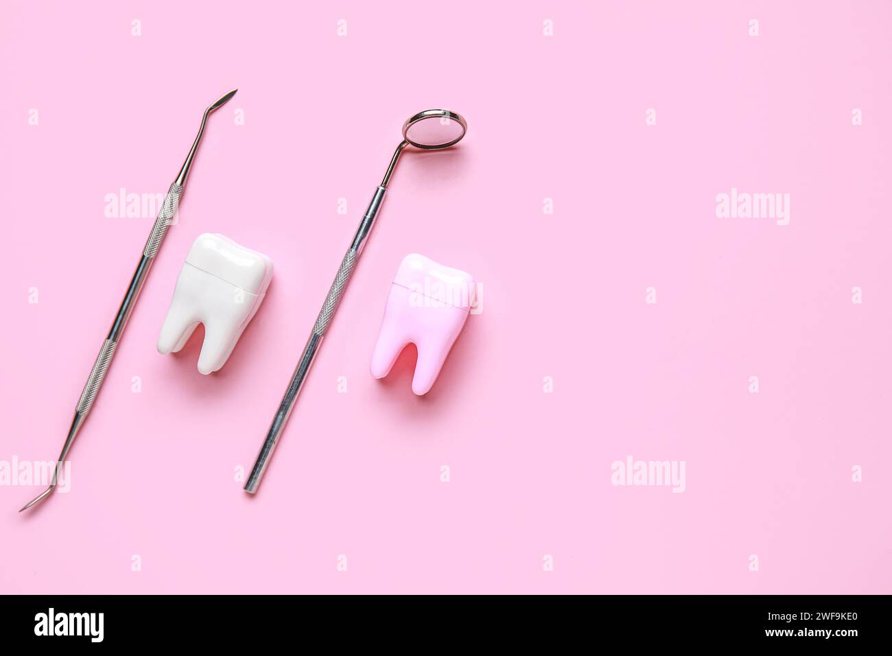 Dental tools and tooth models on pink background. World Dentist Day ...