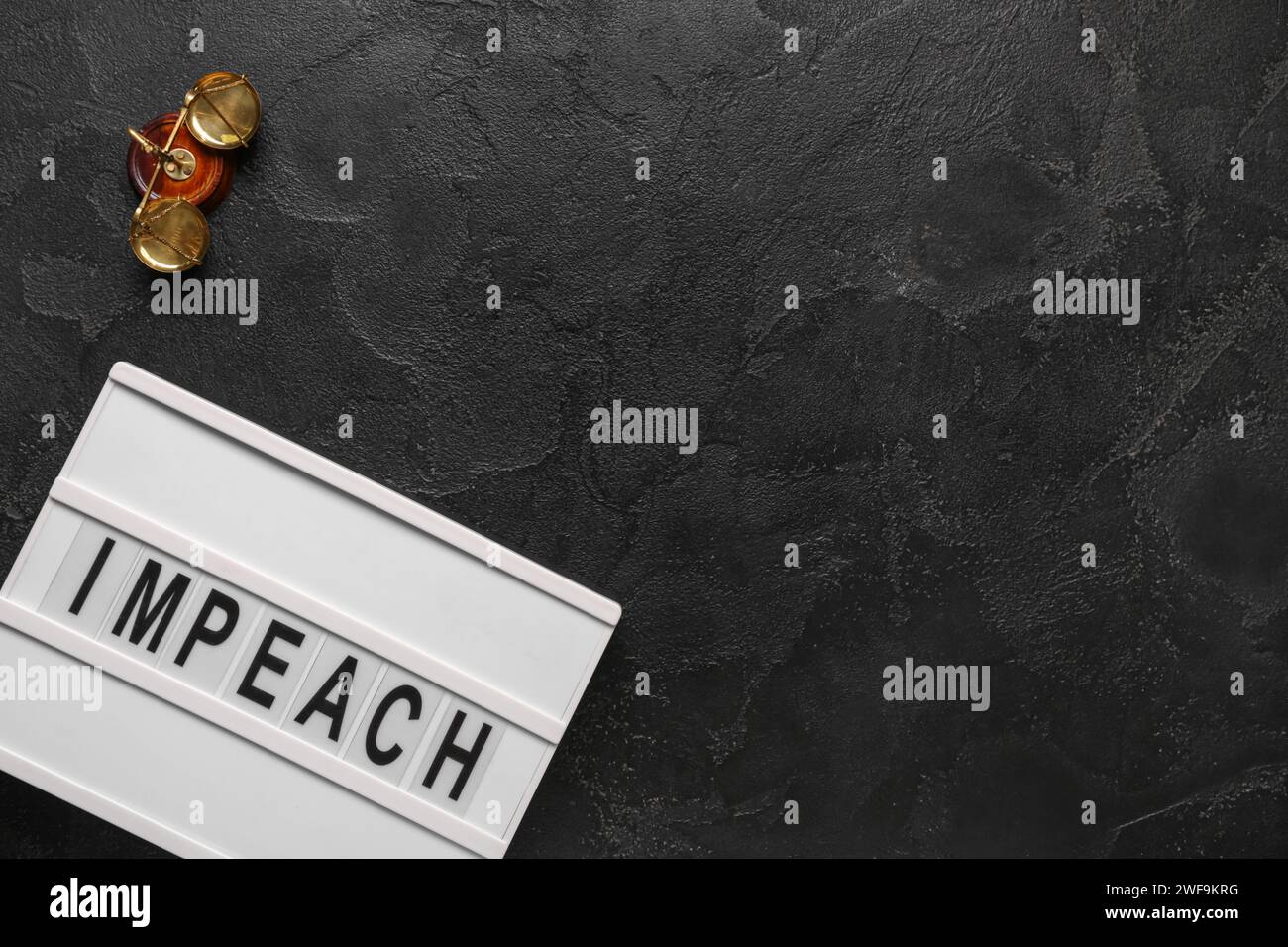 Board with word IMPEACH and scales of justice on black grunge ...