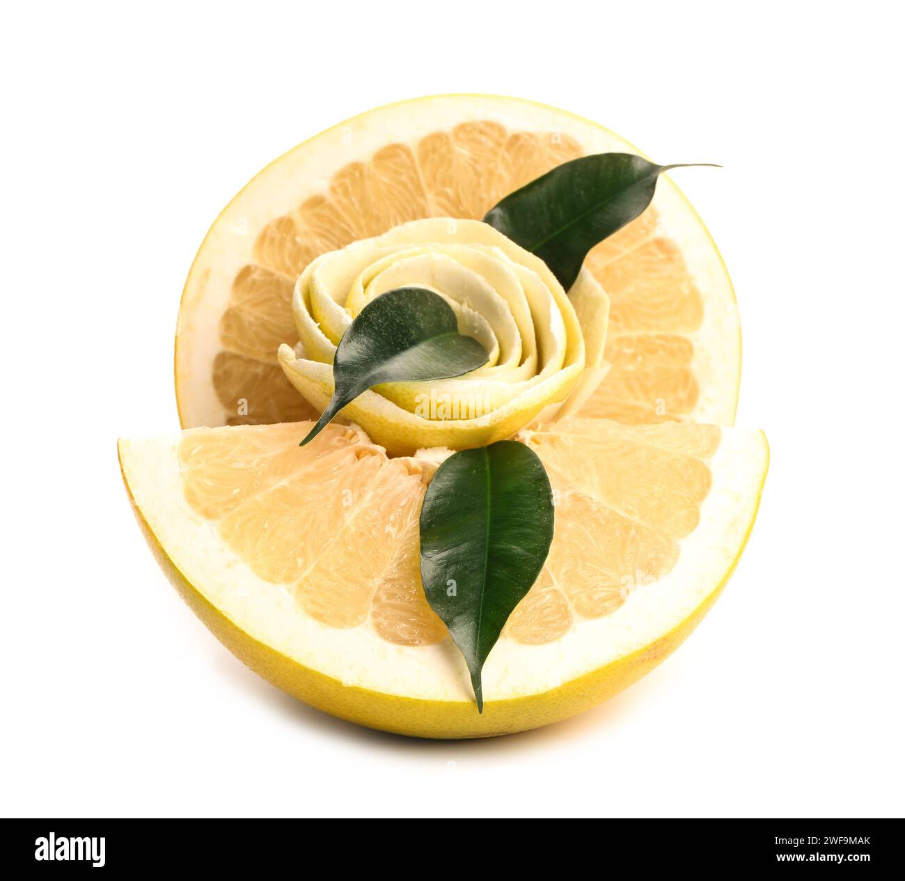 Cut fresh pomelo fruit and leaves on white background Stock Photo - Alamy