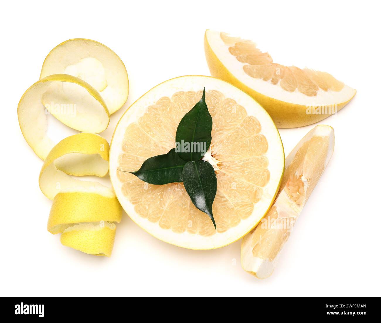Cut fresh pomelo fruit and leaves on white background Stock Photo - Alamy