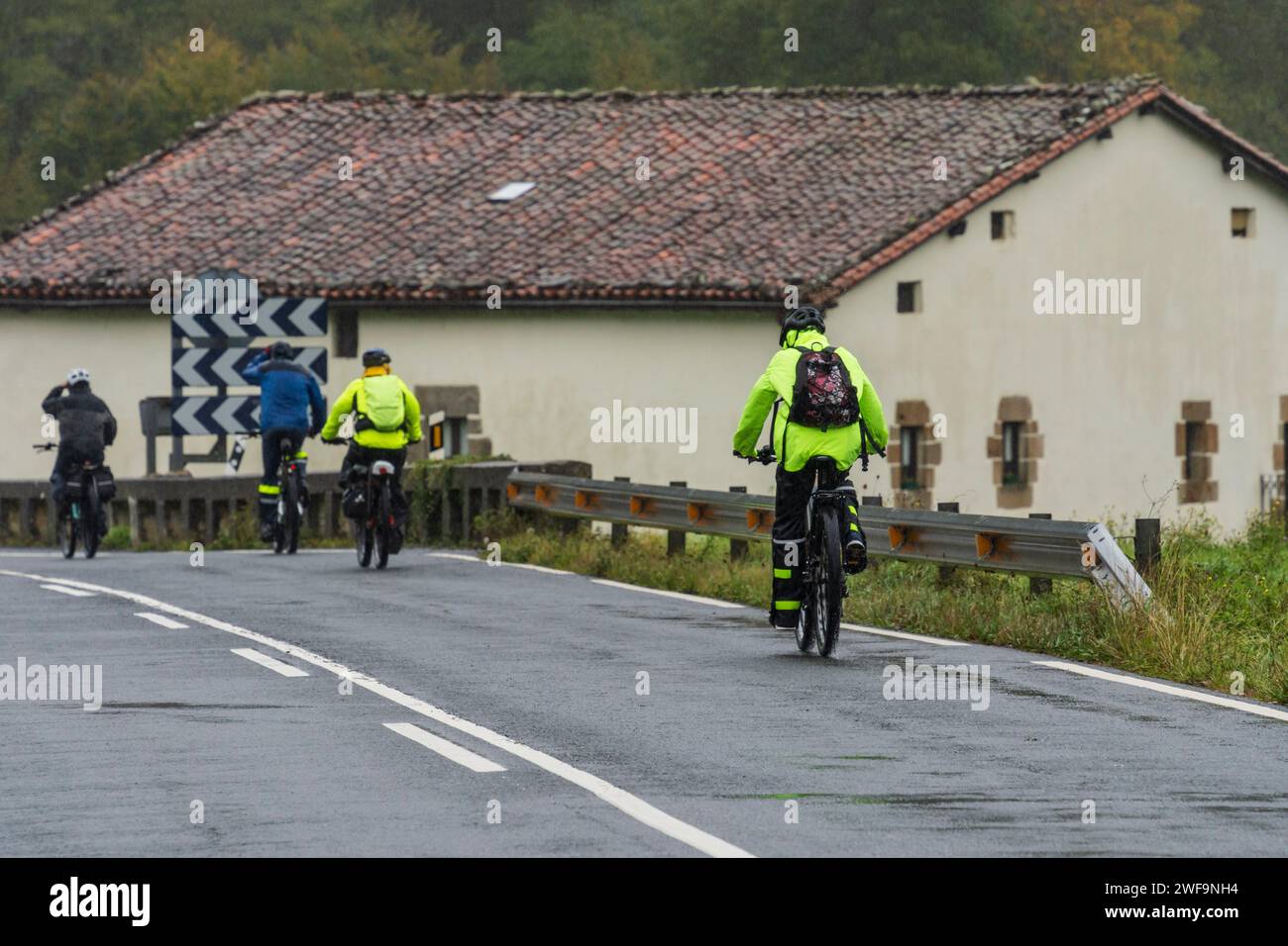 cyclists in the rain, Segura, Idiazabal, Gipuzkoa, Basque country ...