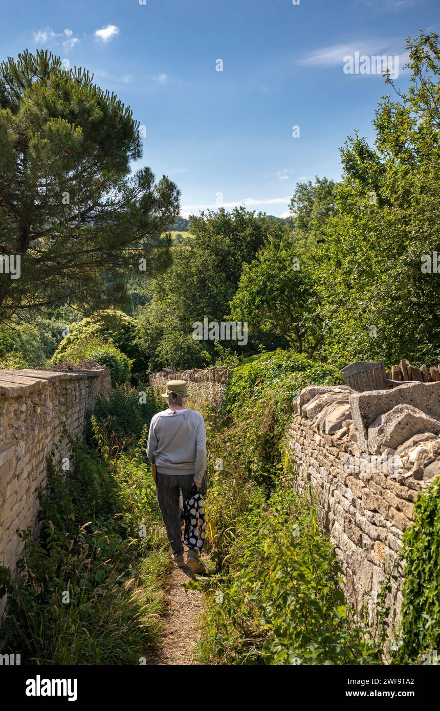 UK, England, Gloucestershire, Painswick, Vicarage Street, walker on ...