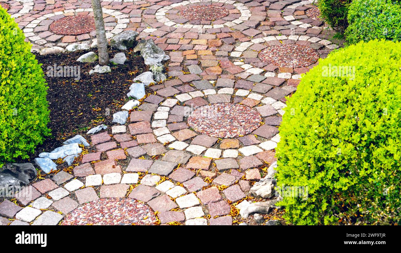 Circular paving of a path near the house and in the garden. An original ...