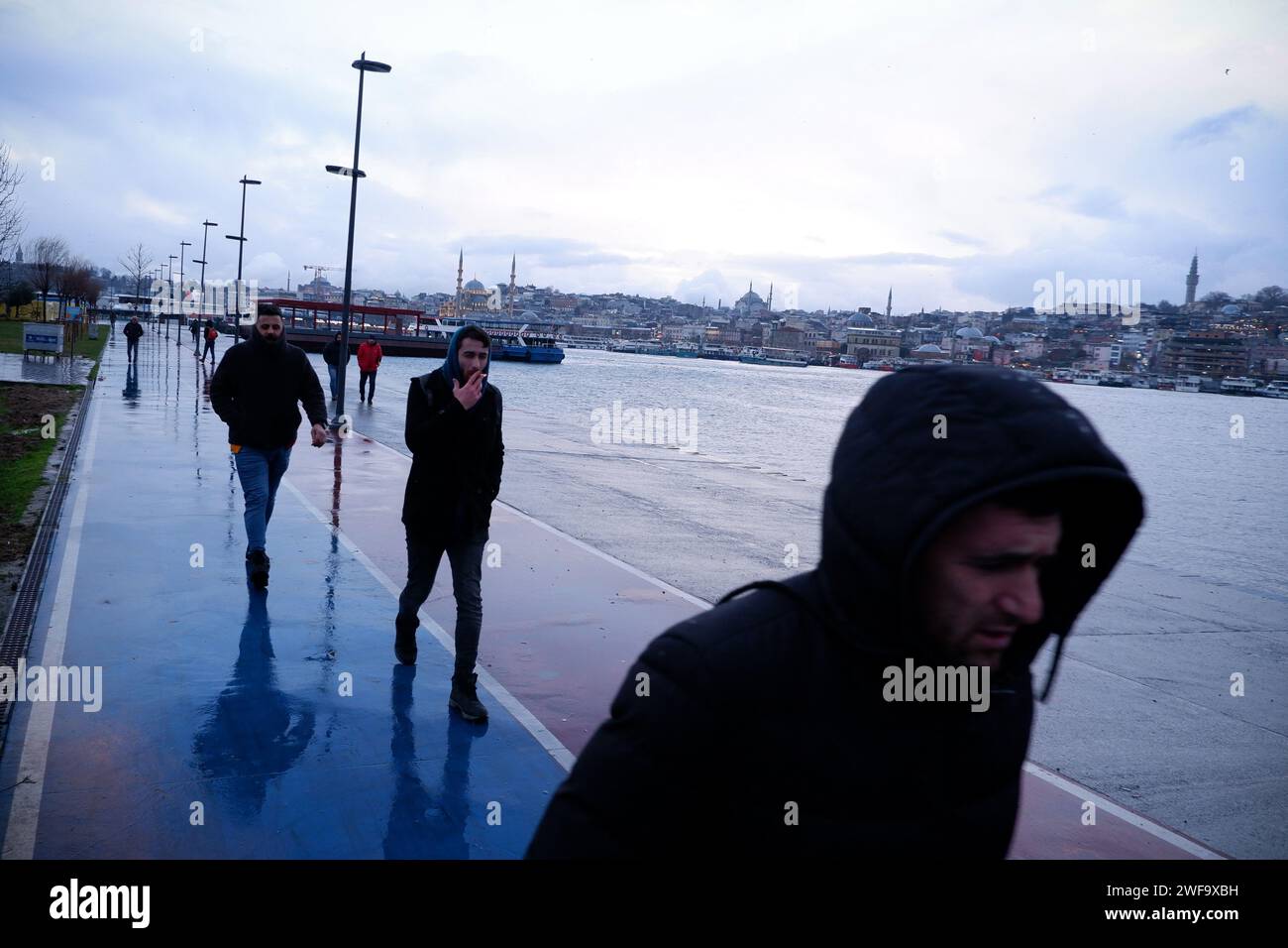 Istanbul, Turkey. 29th Jan, 2024. People walk near the Bosporus Strait ...