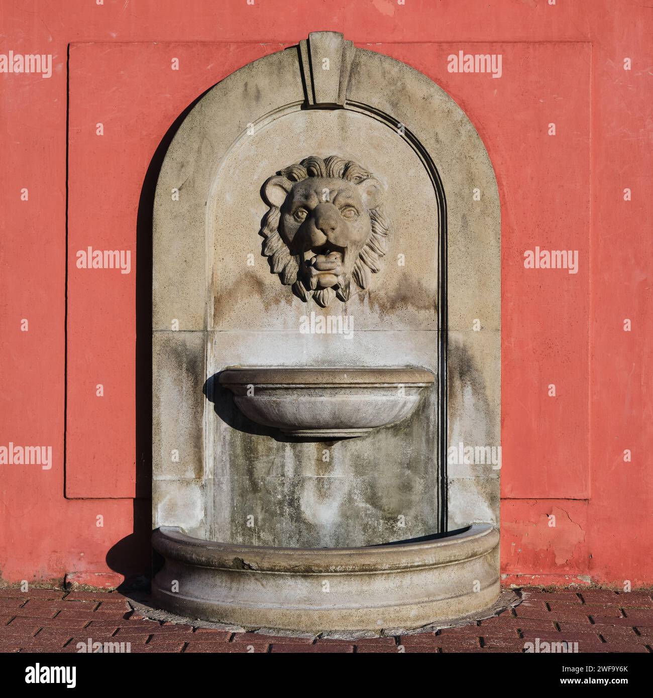 Old antique public water fountain with flowing water in the town hall ...