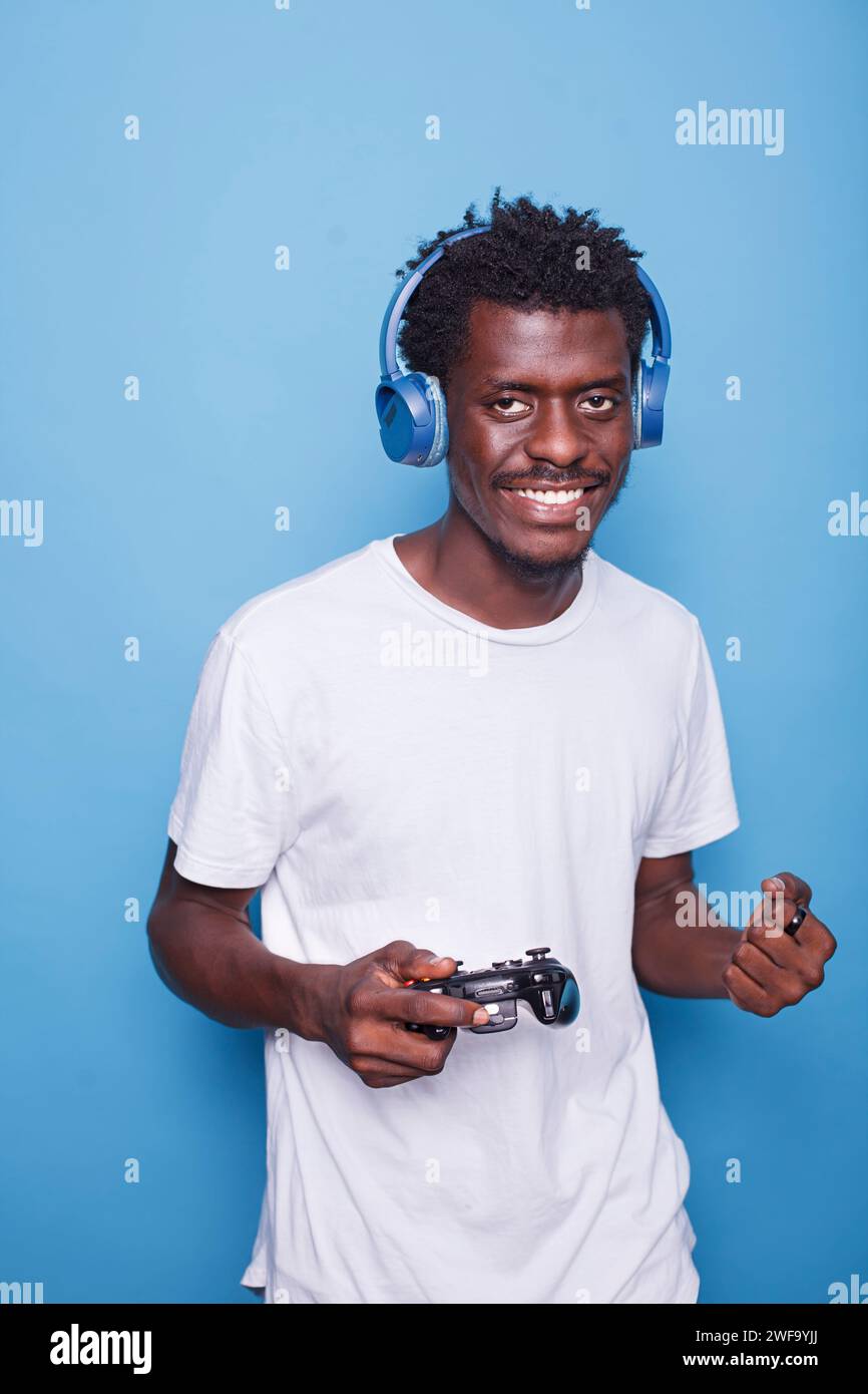 Portrait of african american gamer celebrating victory of video game in ...