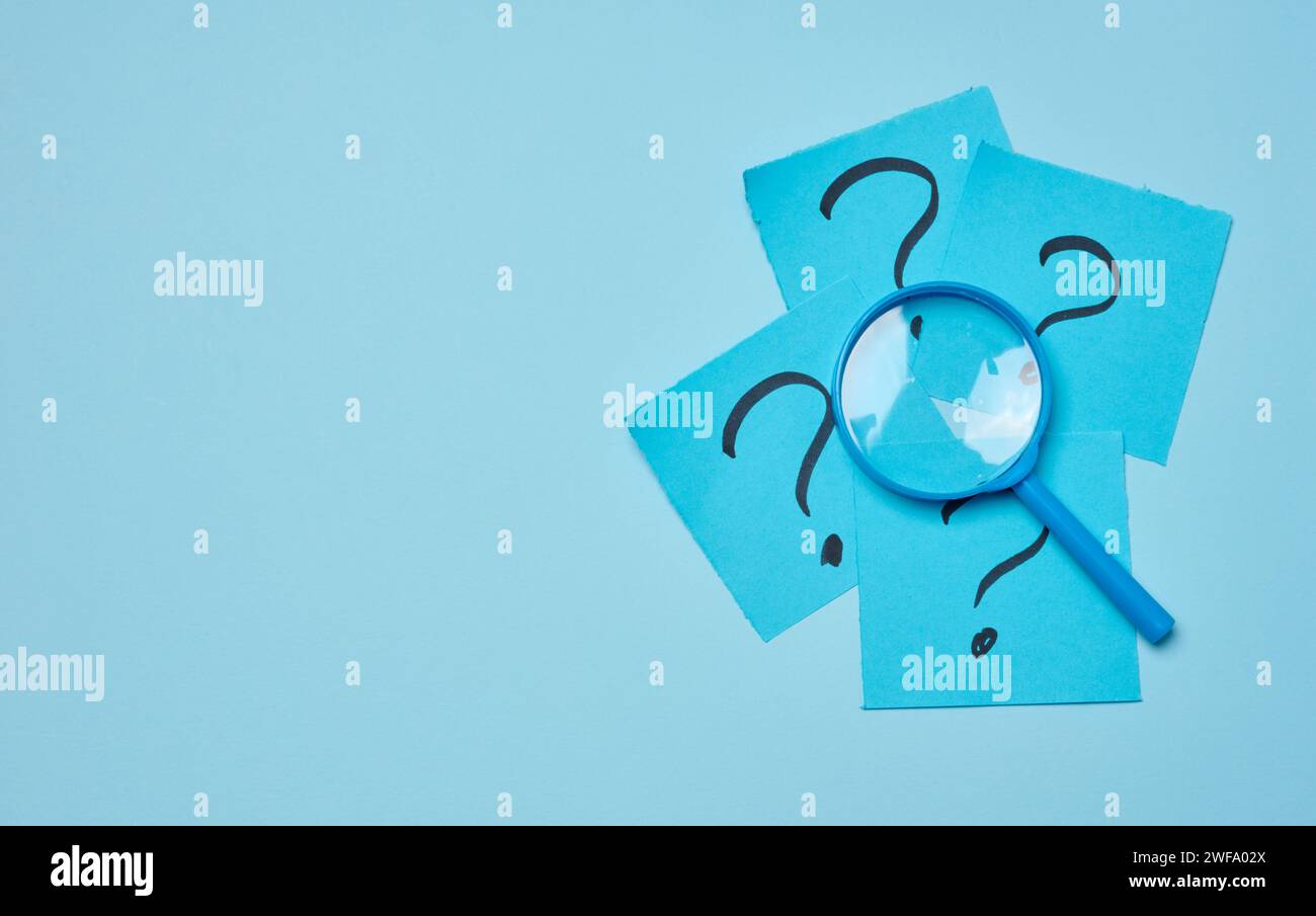 Drawn question marks on stickers and a magnifying glass, blue ...