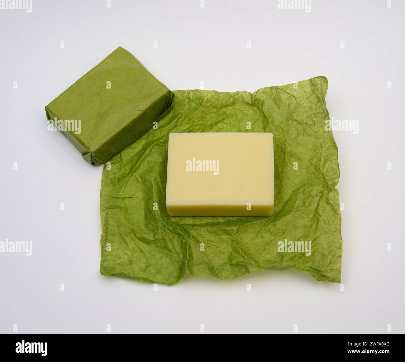 bar of soap on green paper wrapper on white background Stock Photo - Alamy