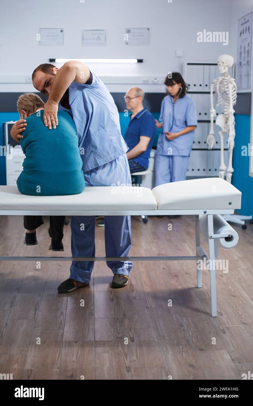 Osteopathy specialist relieving pressure from back bones of senior ...
