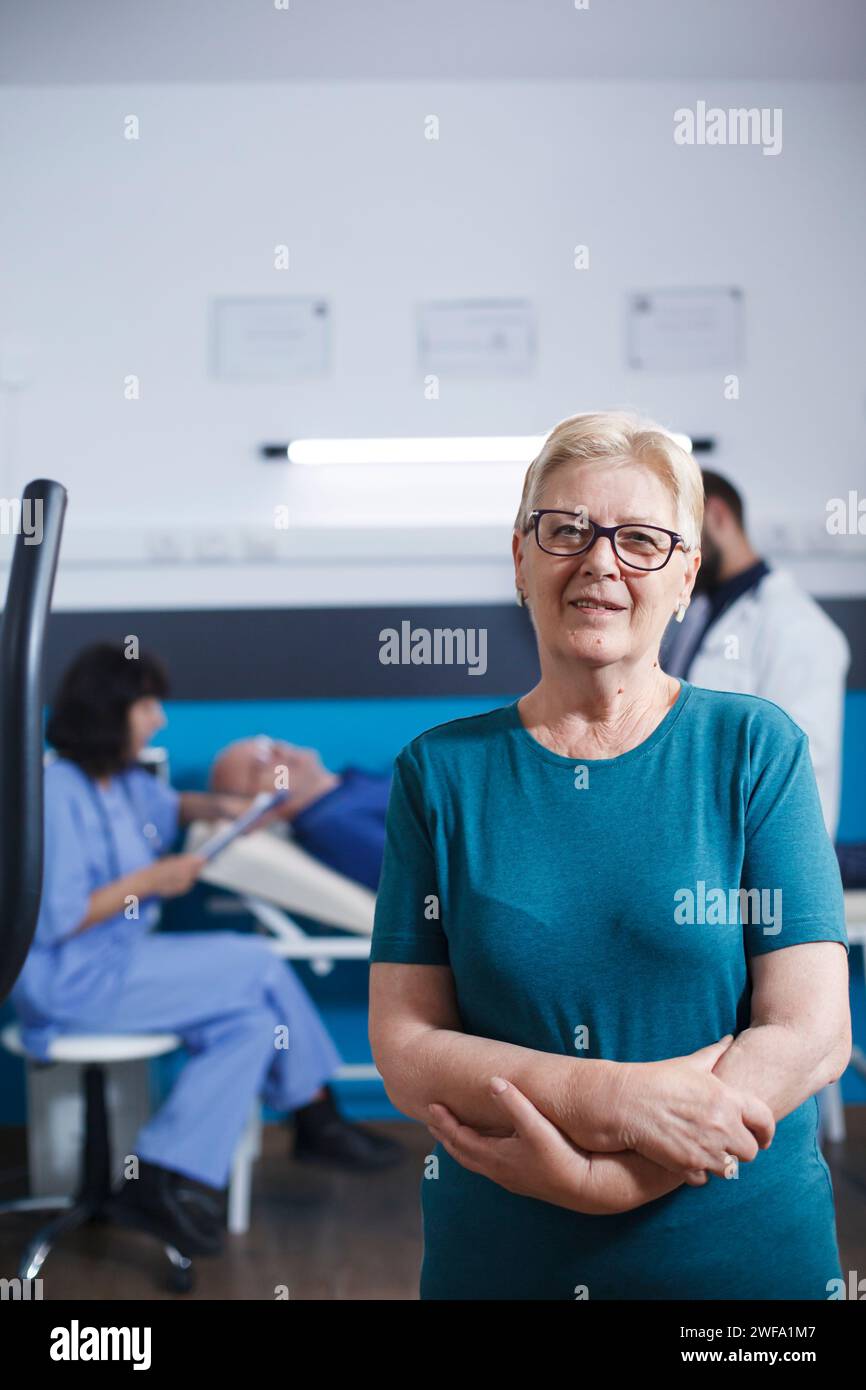 Old woman in portrait waits to work out for physical treatment with ...