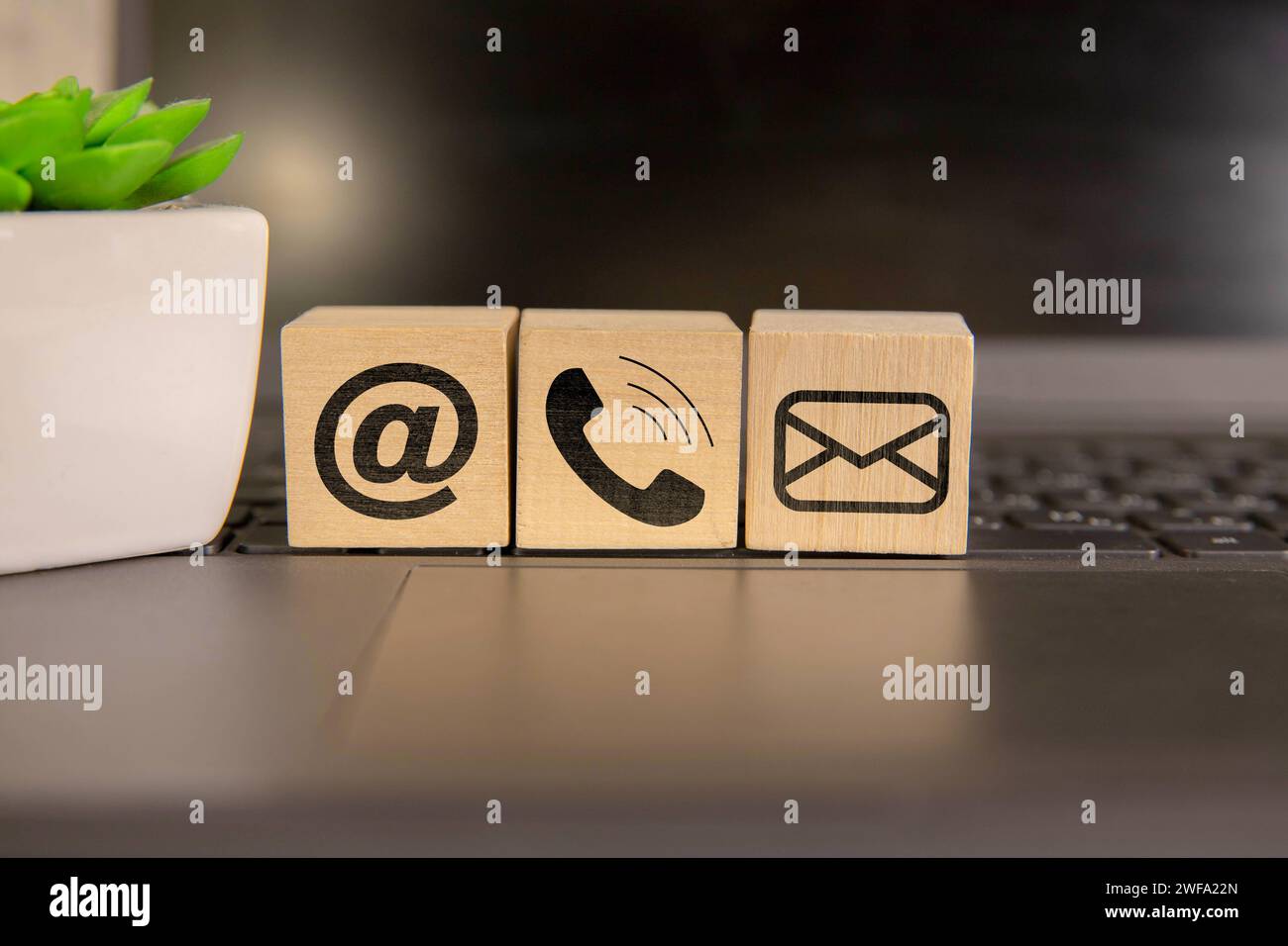 Contact Methods. Close-up of a phone, email, chat and post icons wooden ...