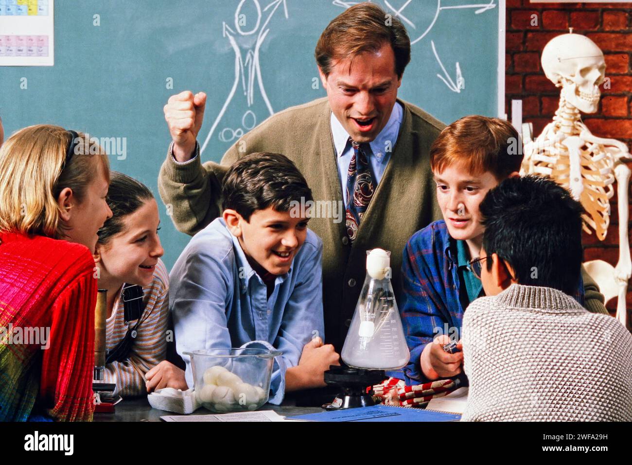 An enthusiastic teacher conducting a scientific experiment in his ...