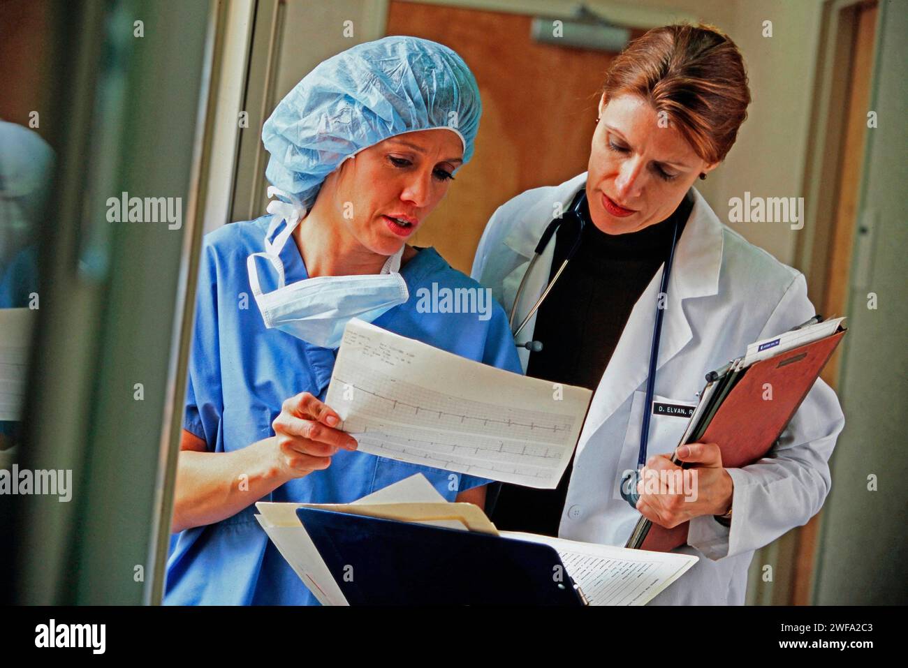 Dr. and surgeon discussing a patient's medical records Stock Photo - Alamy