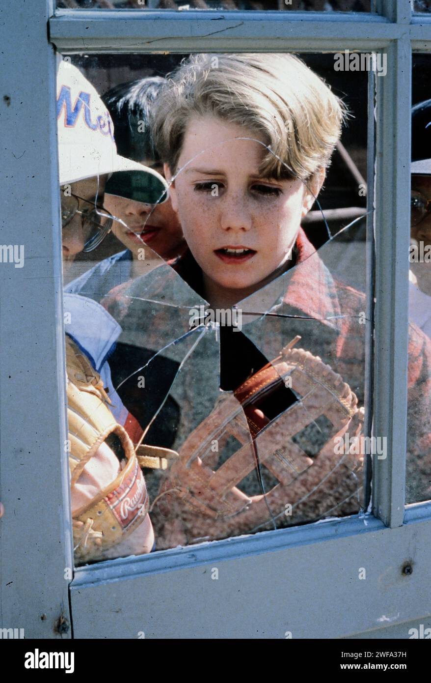 The photo captures a poignant moment as a young boy looks out through ...