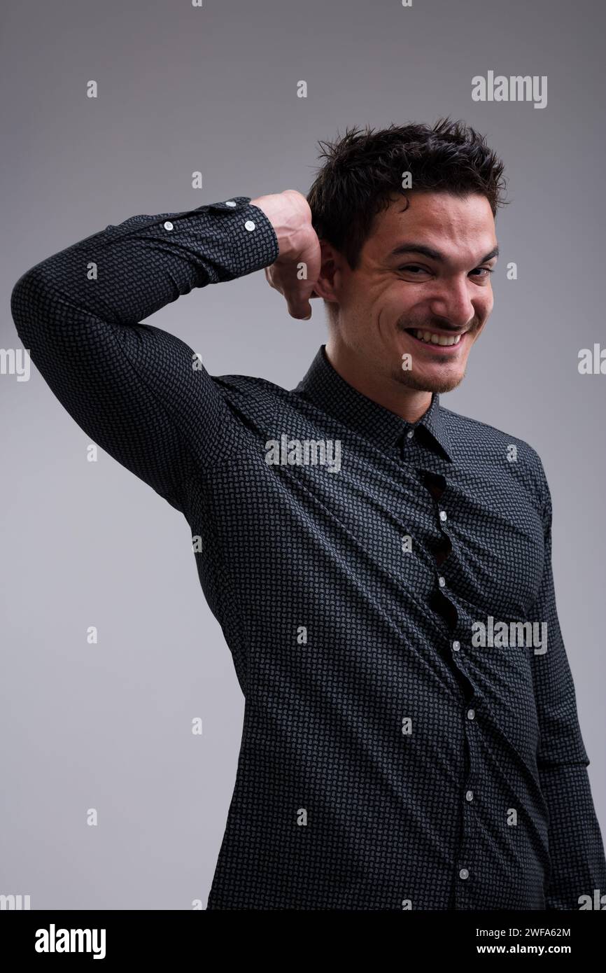Thoughtful man, short-haired, wearing a long-sleeved dark shirt, smiles ... Thoughtful man, short-haired, wearing a long-sleeved dark shirt, smiles ...