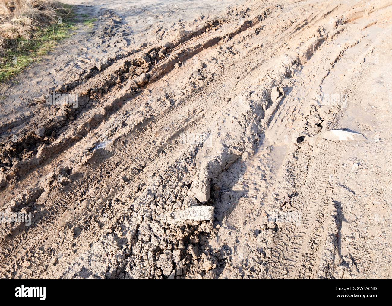 Frost, sheets of ice on a muddy road, frost-covered grasses, mud, ice ...