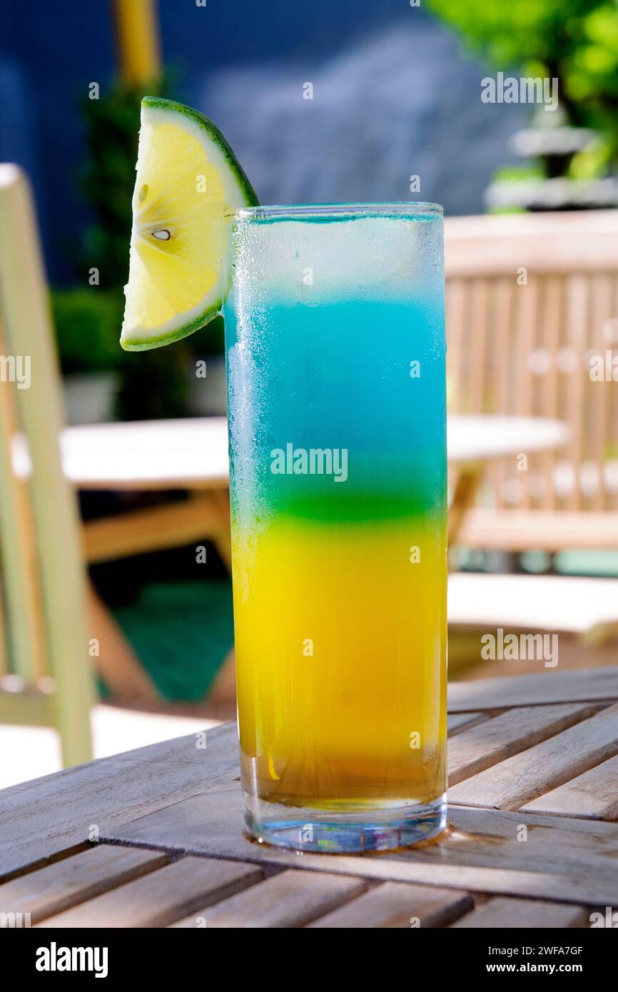 A glass of lime squash delight served with ice is placed on the table ...