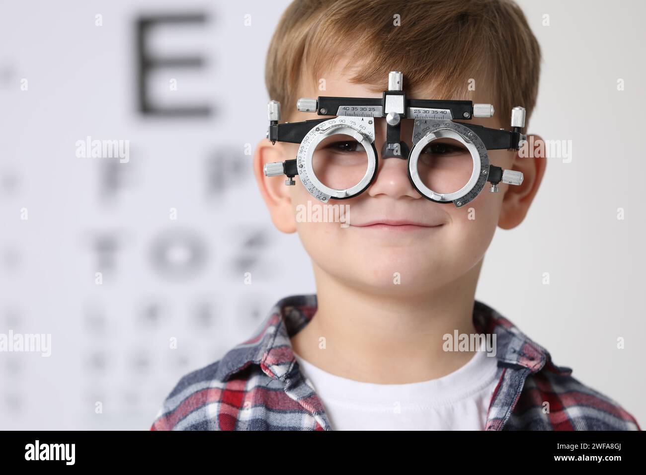 Little boy with trial frame against vision test chart Stock Photo - Alamy