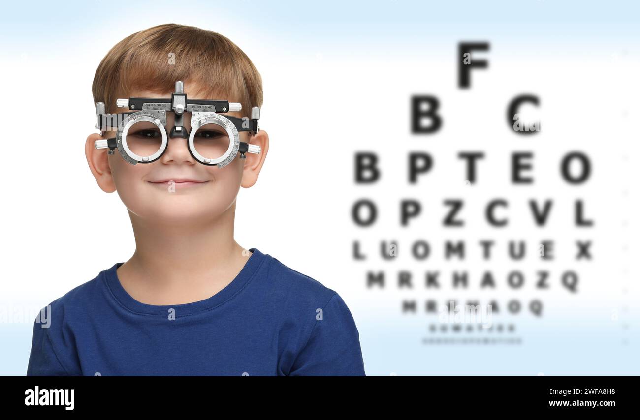Vision test. Little boy with trial frame and eye chart on gradient ...