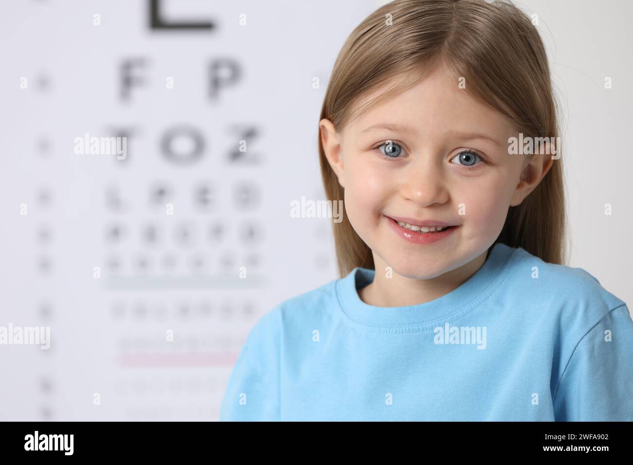 Cute little girl against vision test chart Stock Photo - Alamy