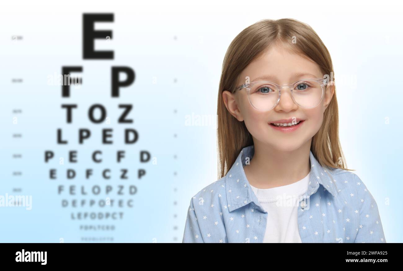 Vision test. Little girl in glasses and eye chart on gradient ...
