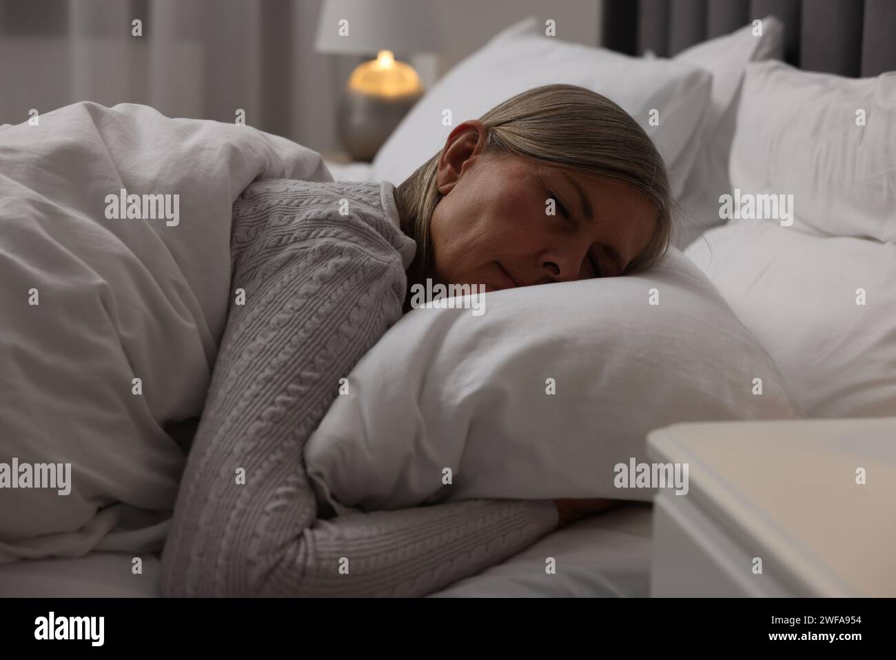 Menopause. Woman sleeping in bed at home Stock Photo - Alamy