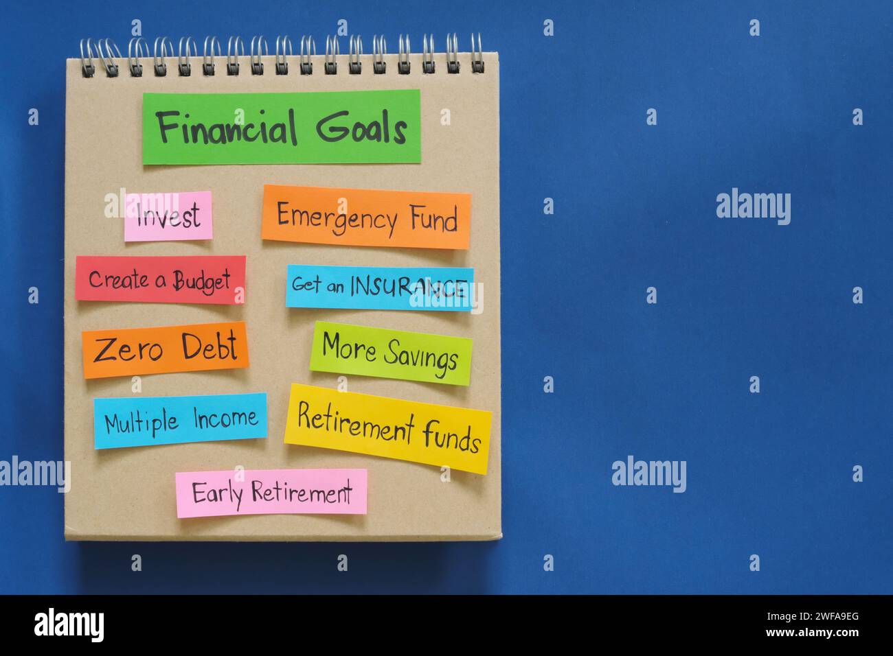 Financial goals concept. Checklist of goals in note pad in blue ...