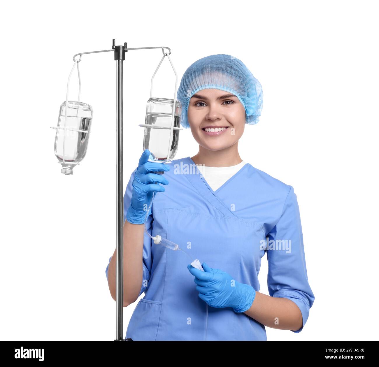 Nurse setting up IV drip on white background Stock Photo - Alamy