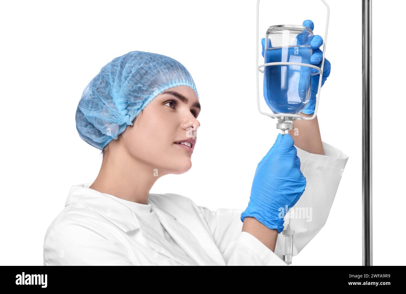 Nurse setting up IV drip on white background Stock Photo - Alamy
