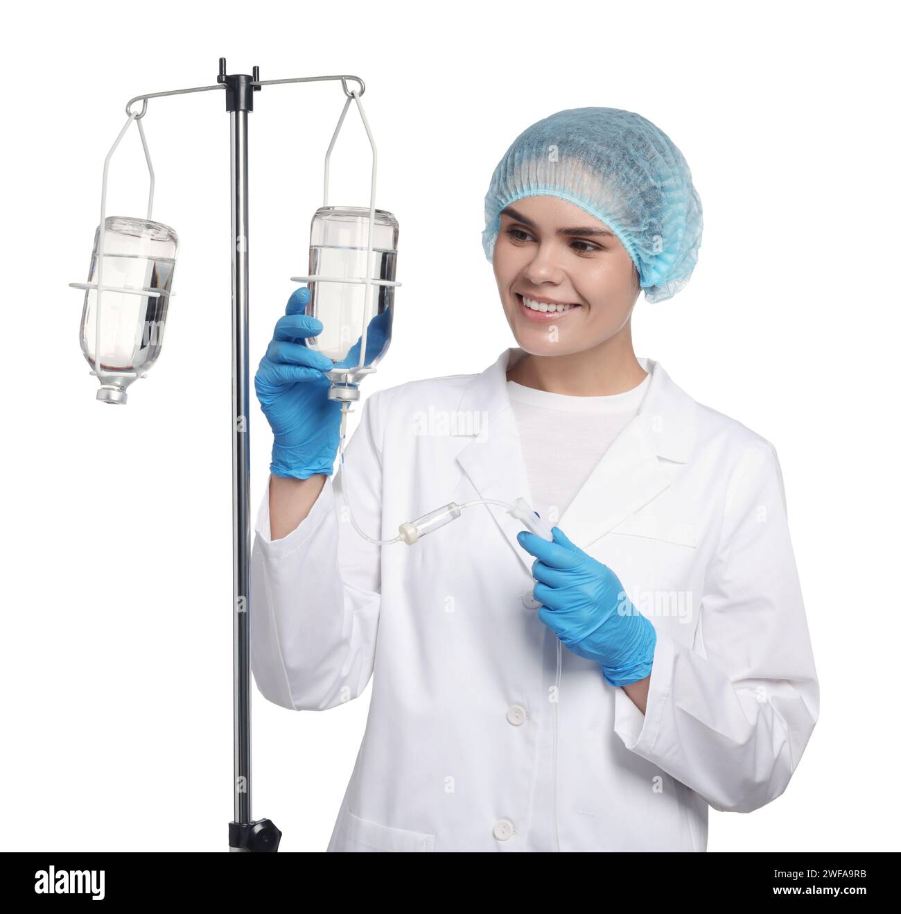 Nurse setting up IV drip on white background Stock Photo - Alamy