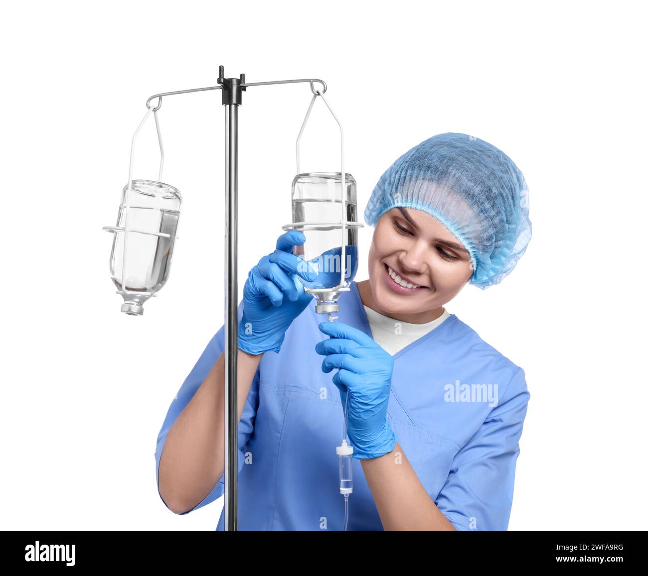Nurse setting up IV drip on white background Stock Photo - Alamy