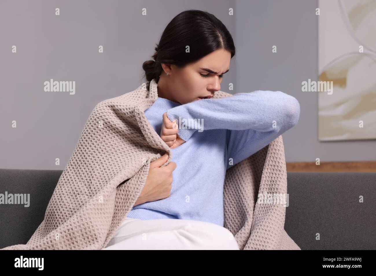 Woman coughing on sofa hi-res stock photography and images - Alamy