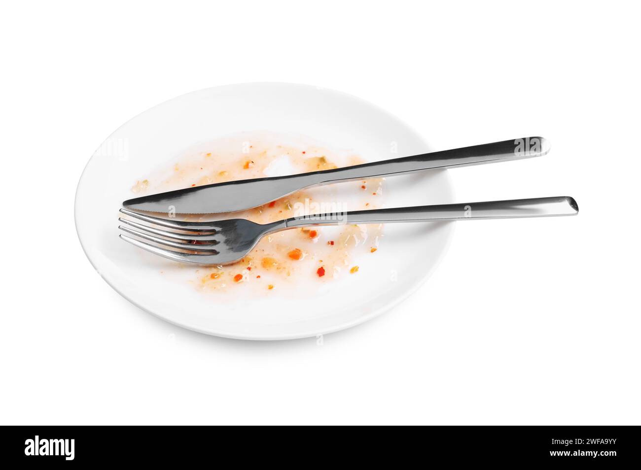 Dirty plate and cutlery on white background Stock Photo - Alamy