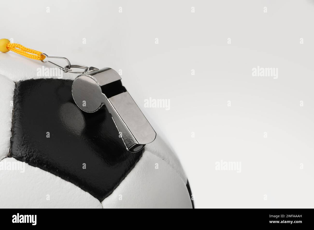 Football referee equipment. Soccer ball and whistle on white background ...