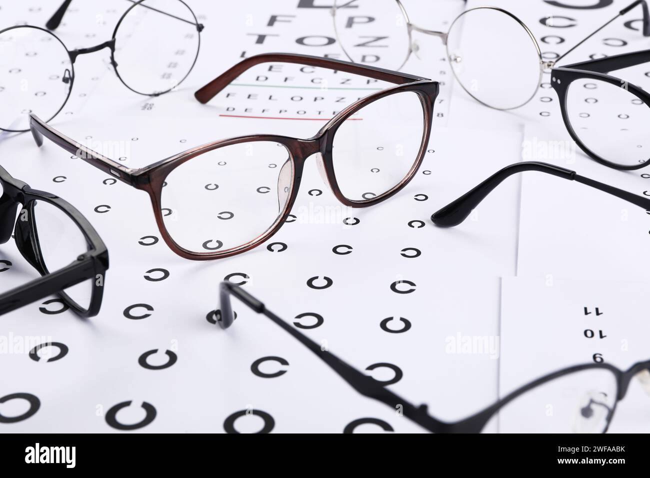 Vision test charts and glasses on table Stock Photo - Alamy