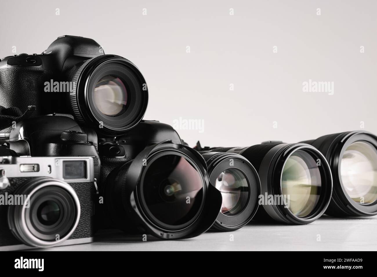 Modern cameras on white background, space for text Stock Photo - Alamy