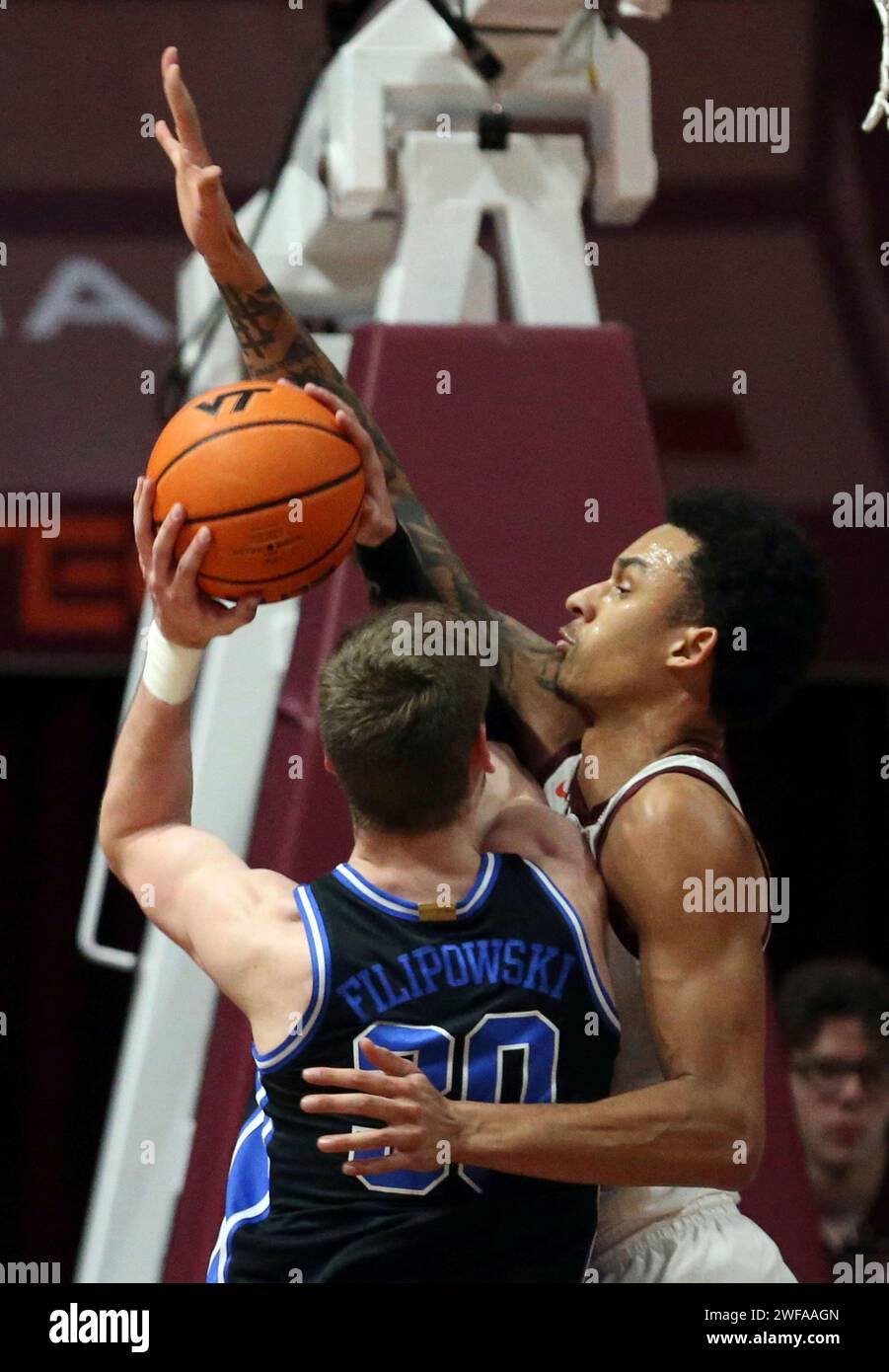 Duke's Kyle Filipowski, left, is defended by Virginia Tech's Lynn Kidd ...