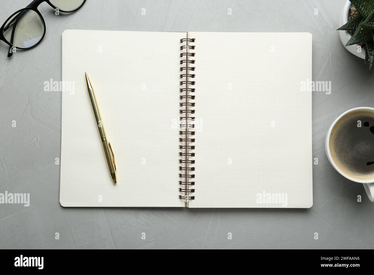 Flat lay composition with open notebook on light textured table. Space ...