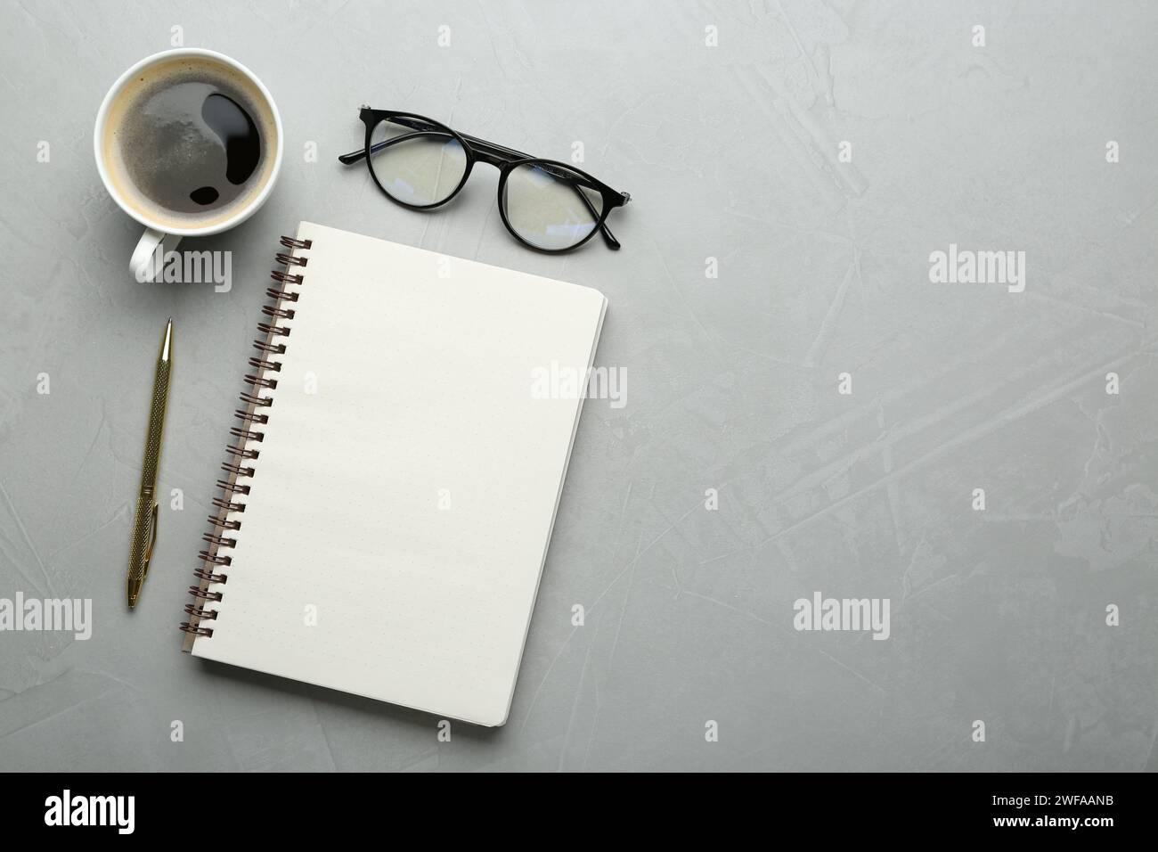Flat lay composition with open notebook on light textured table. Space ...