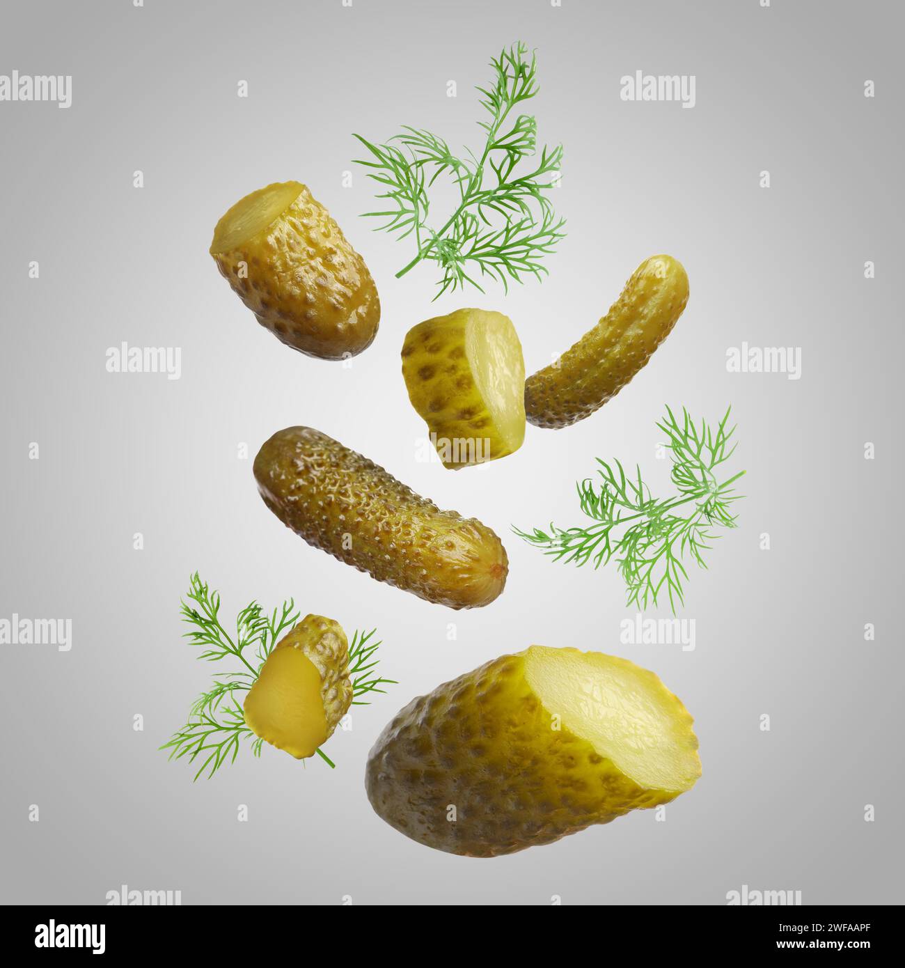 Tasty pickled cucumbers and dill falling on light grey background Stock ...