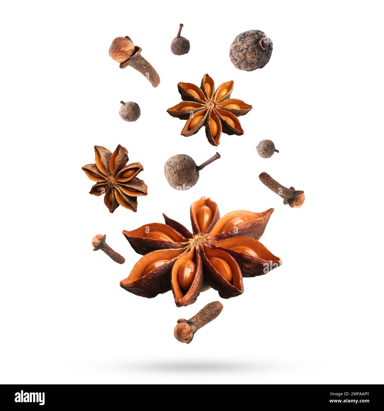 Different aromatic spices falling on white background Stock Photo - Alamy