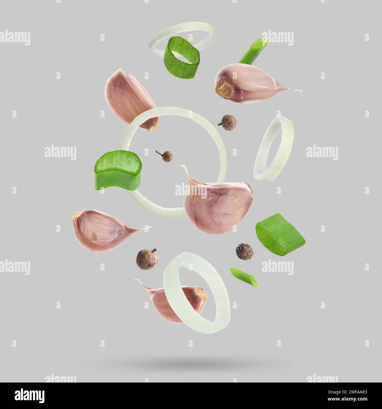 Different spices falling on light grey background Stock Photo - Alamy