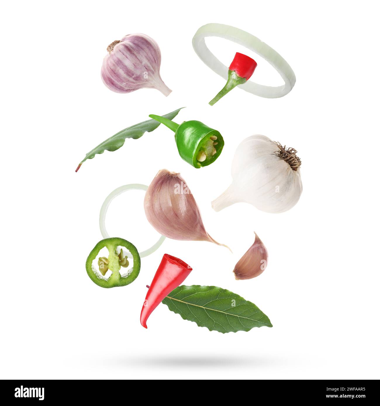 Different aromatic spices falling on white background Stock Photo - Alamy