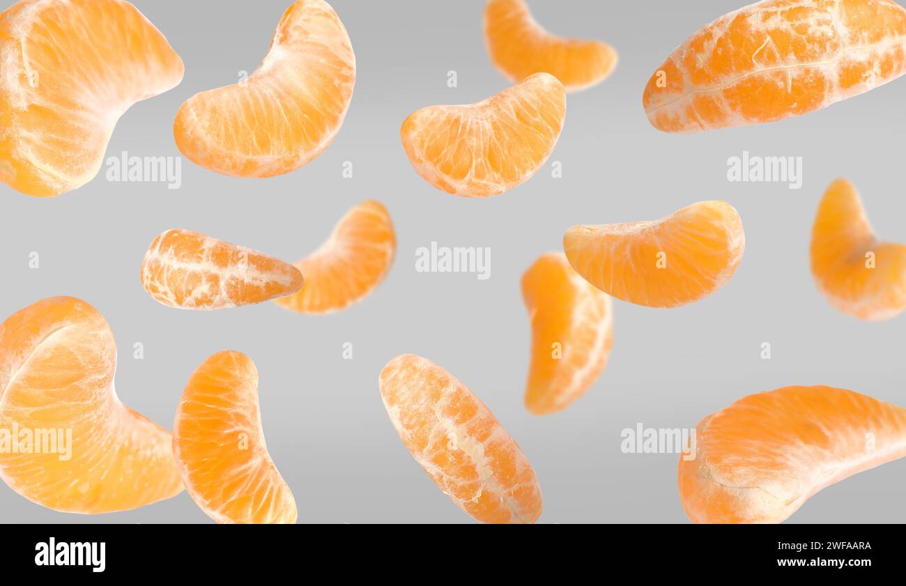Pieces of fresh ripe tangerine falling on grey background, banner ...