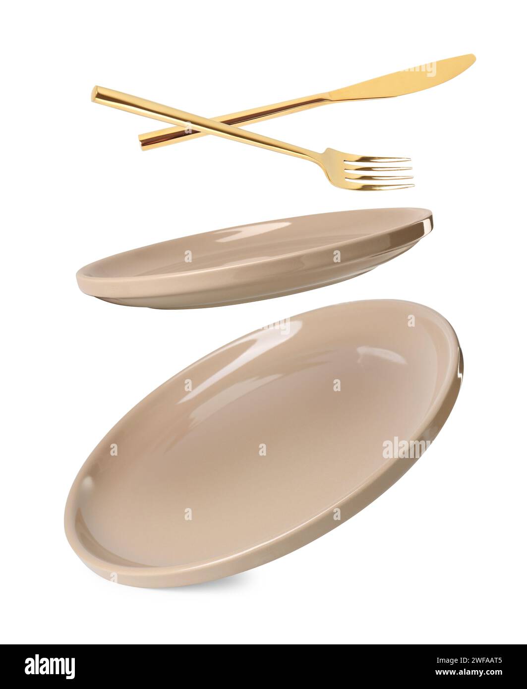 Clean plates, fork and knife falling on white background Stock Photo ...
