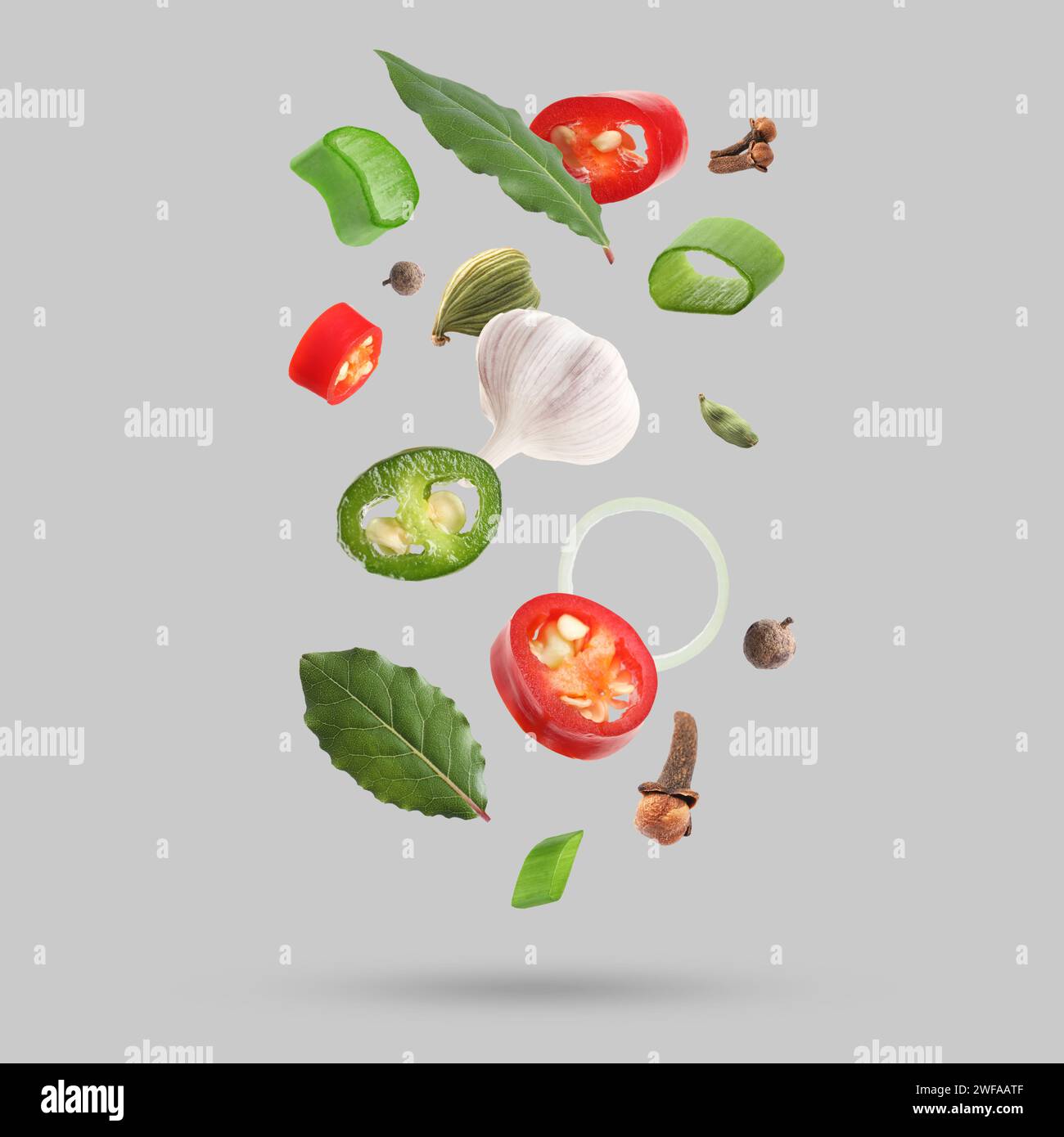 Different spices falling on light grey background Stock Photo - Alamy