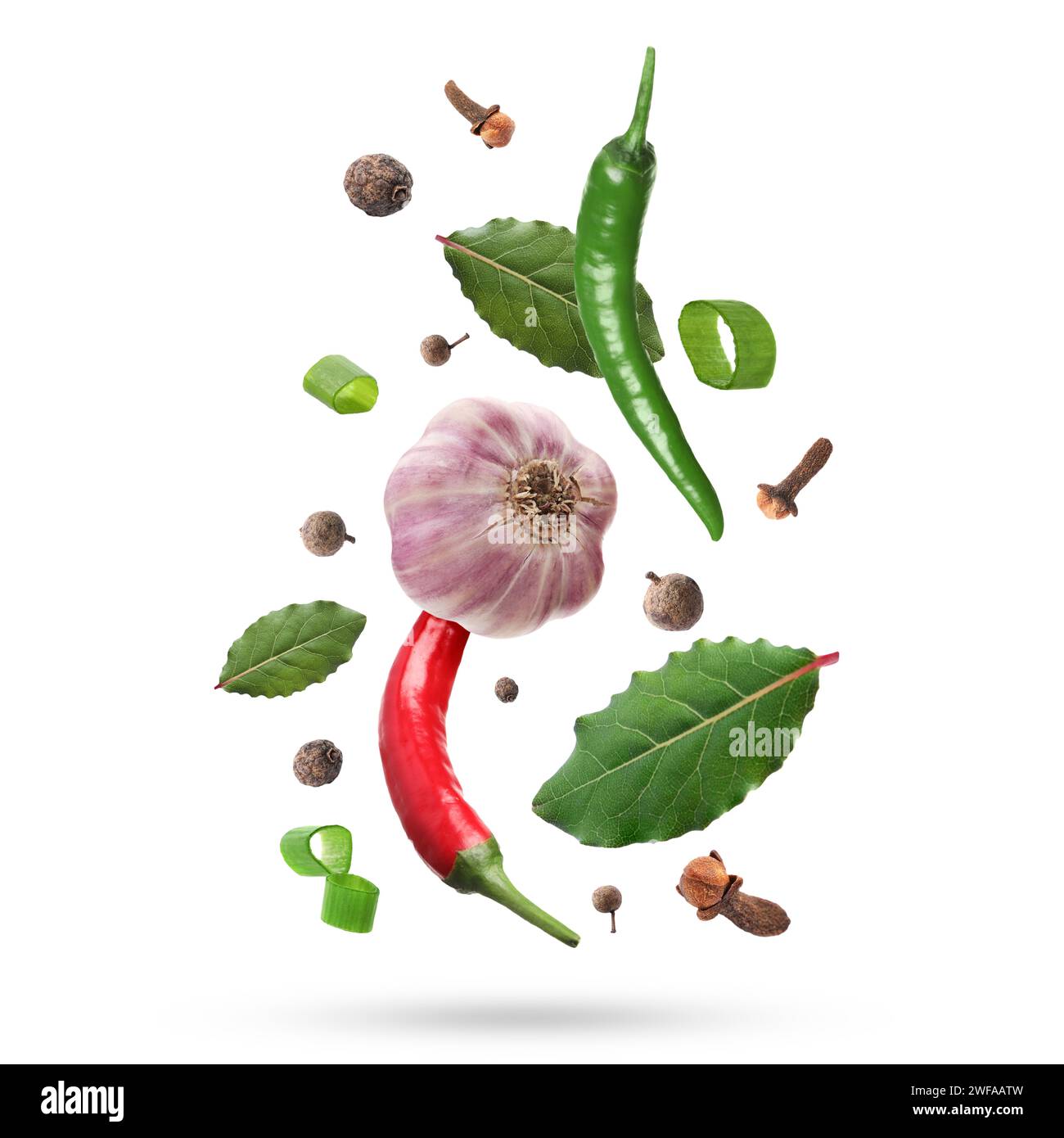 Different aromatic spices falling on white background Stock Photo - Alamy