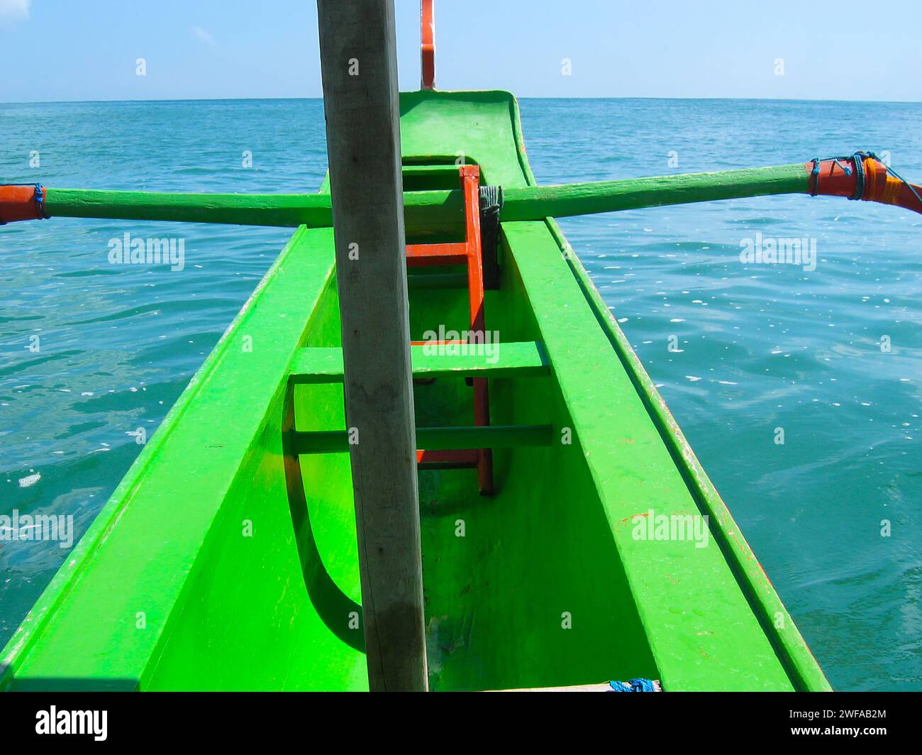 Traditional Balinese wooden outrigger boat in the sea at Kuta, Bali ...